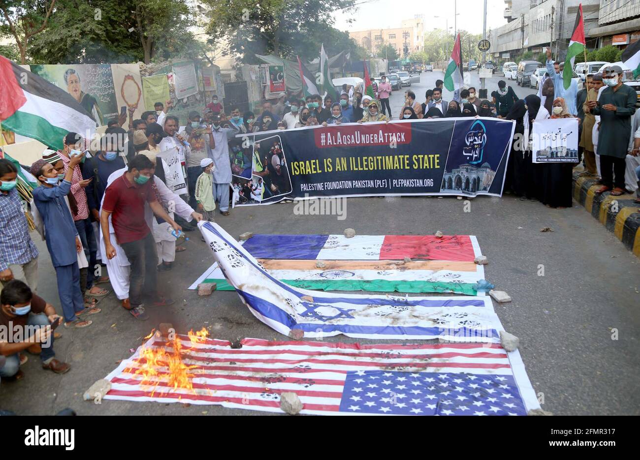 Members of Palestine Foundation Pakistan (PLF) burn flags as they are ...