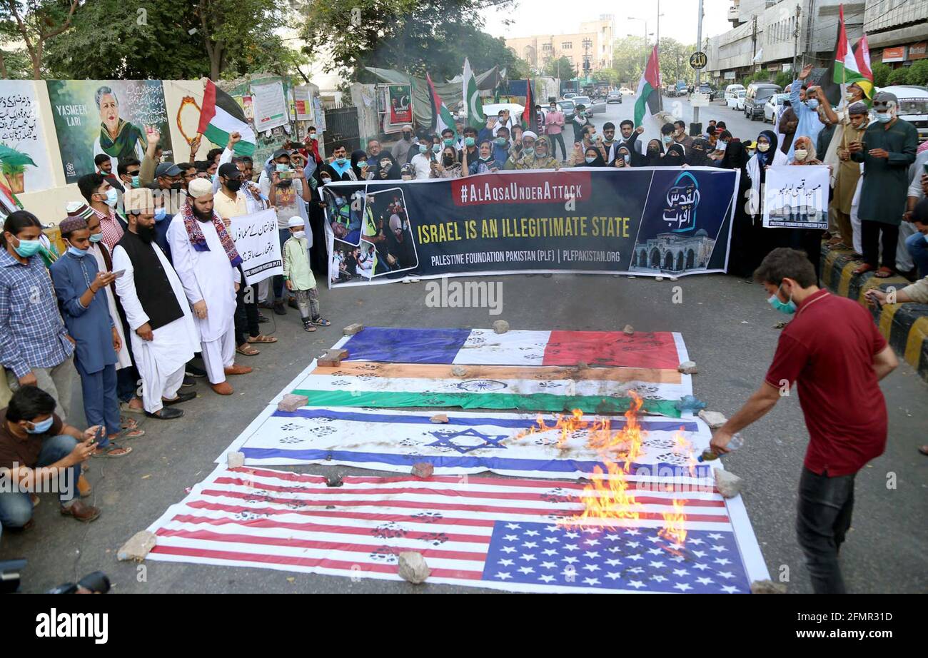 Members of Palestine Foundation Pakistan (PLF) burn flags as they are ...