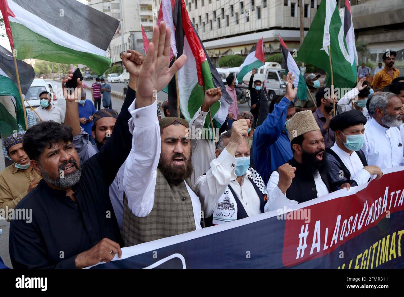 Members of Palestine Foundation Pakistan (PLF) burn flags as they are ...