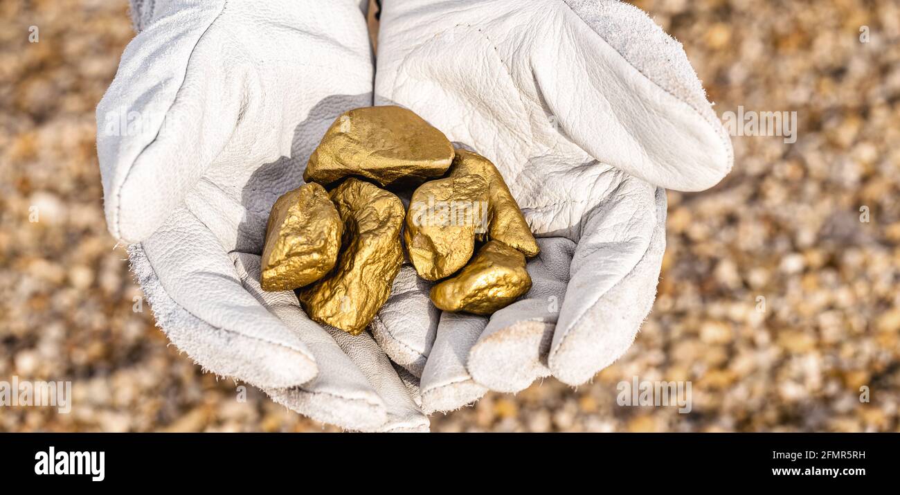 miner hand holding stones from another, gold mineral extraction ...