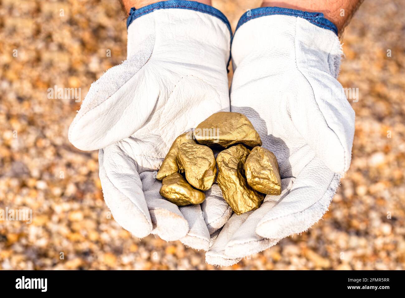miner hand holding stones from another, gold mineral extraction ...