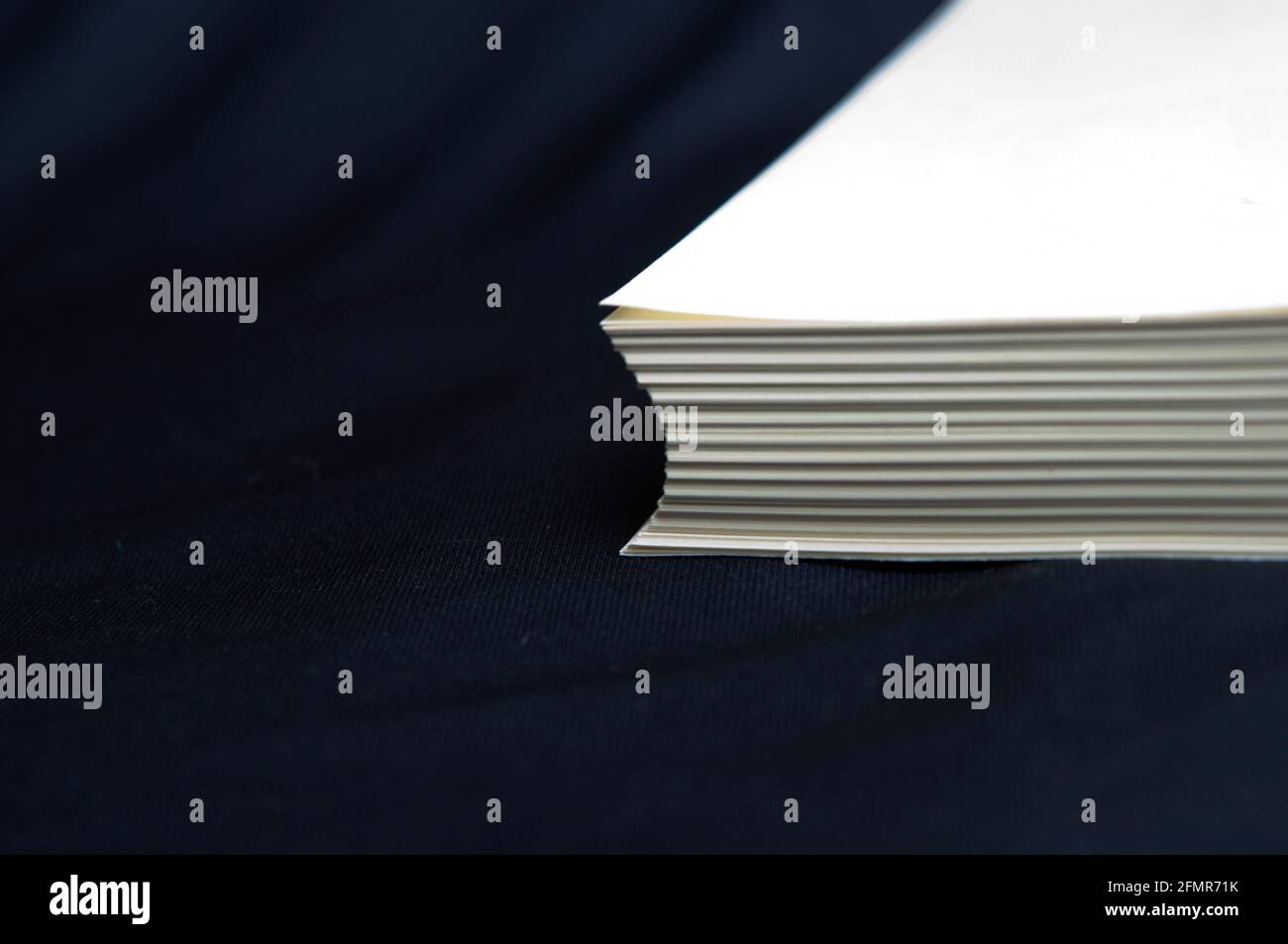 The process of book binding; raw book whiouet covers. Black background ...