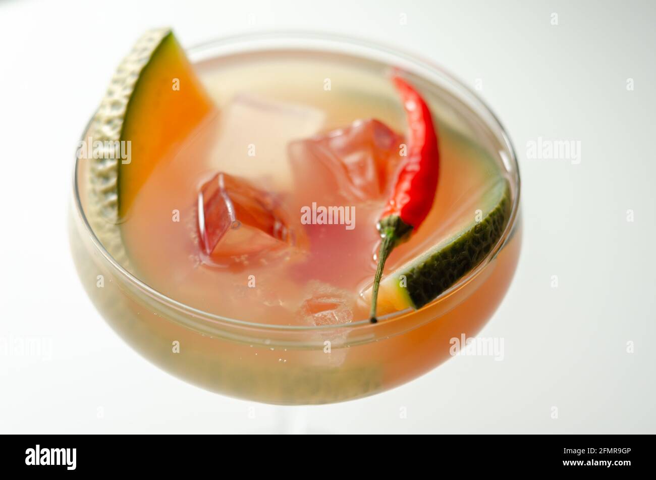 A holiday cocktail based on vodka, liqueur, fresh melon and red bird ...