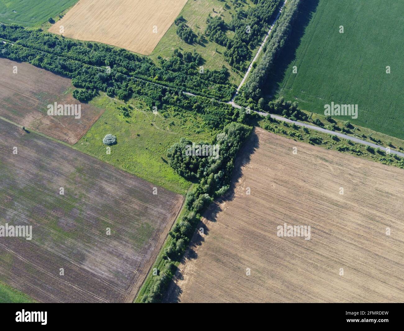 Crossroads of two roads among farm fields, aerial view. Agrarian ...