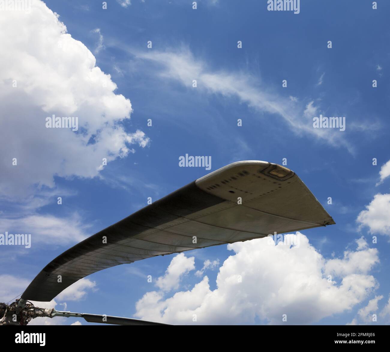 Part of helicopter rotary wings. Helicopter and blue sky with clouds at ...