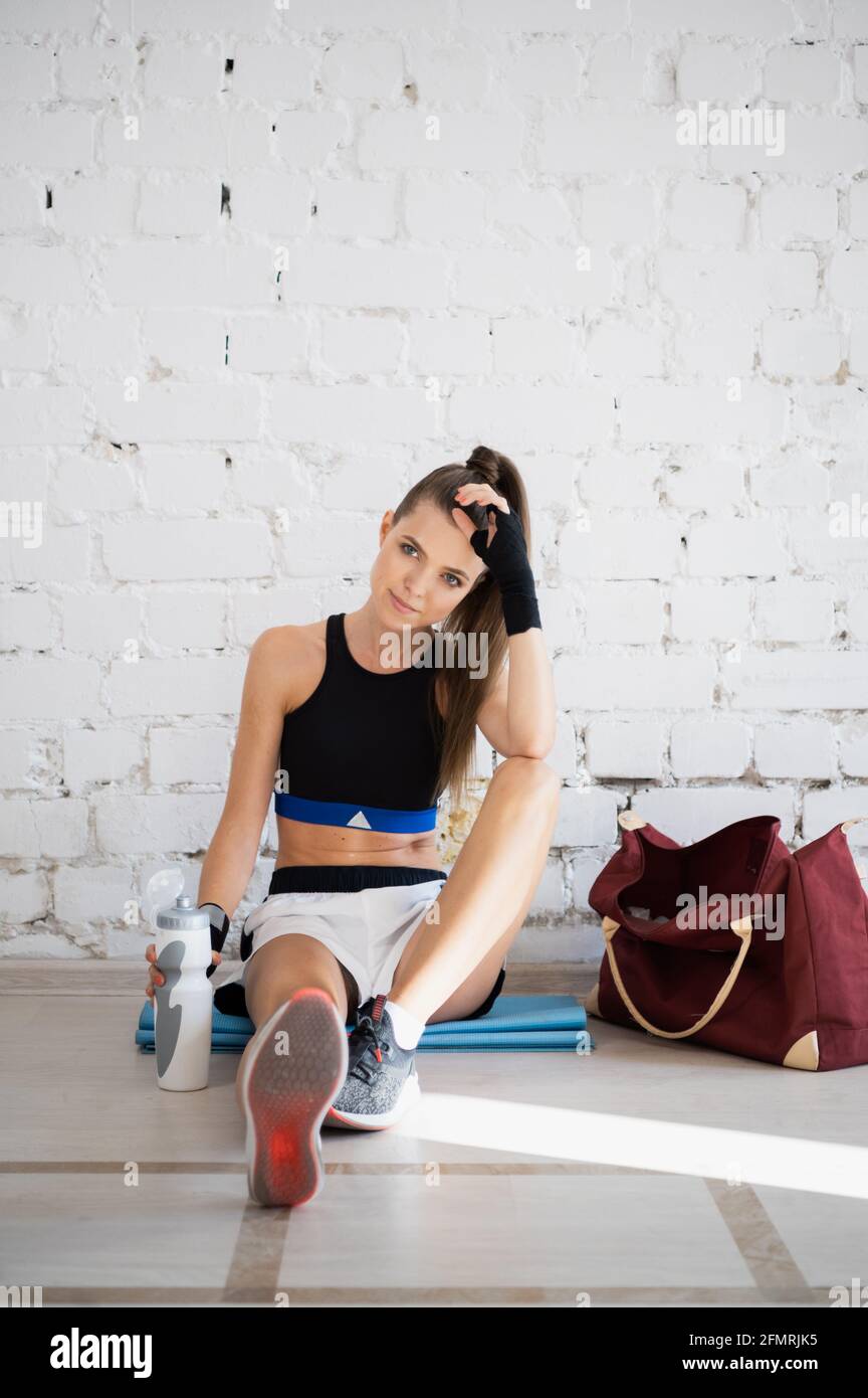 Female fighter exhausted after exercise feeling dehydration, drinks ...