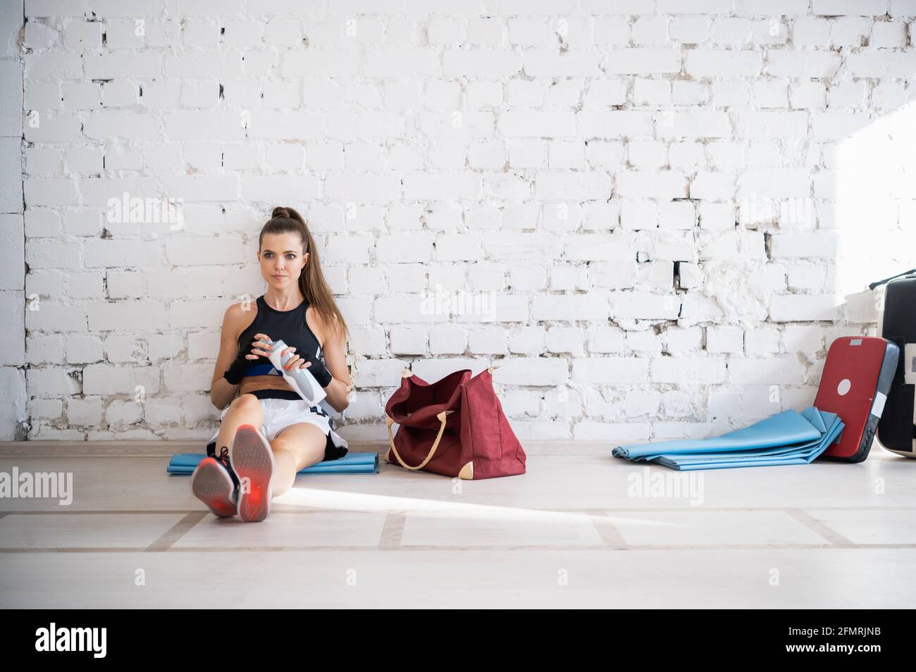 Female fighter exhausted after exercise feeling dehydration, drinks ...