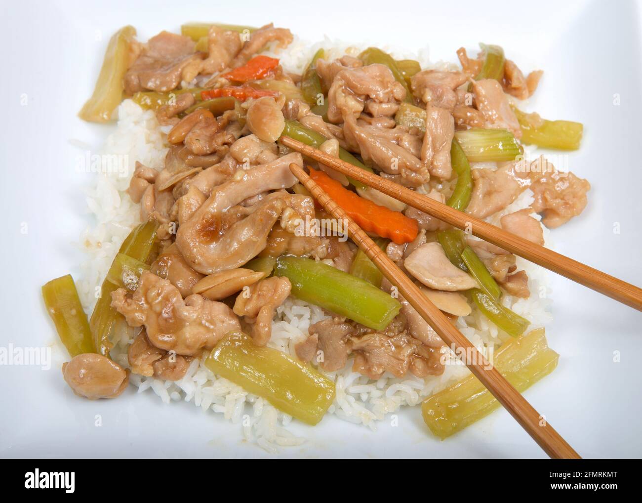 close up flat lay top view of a square plate with Almond Chicken over ...