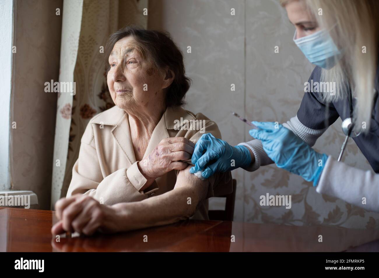 Nurse giving an injection to senior woman Stock Photo - Alamy