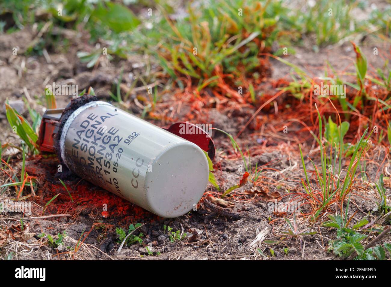 a recently discharged British Army red smoke grenade Stock Photo - Alamy