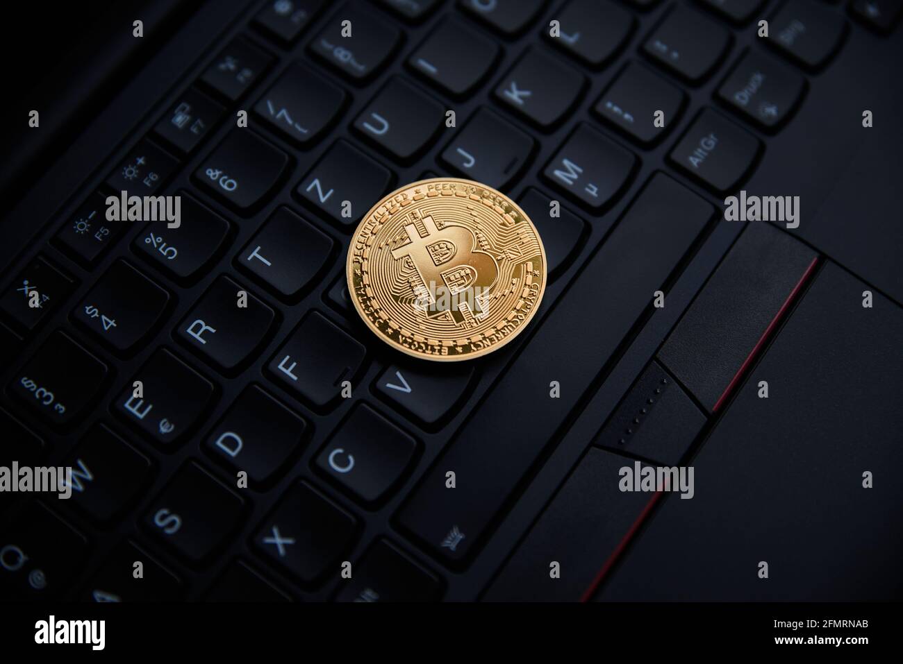 Closeup of a shiny bitcoin medal on a keyboard Stock Photo - Alamy