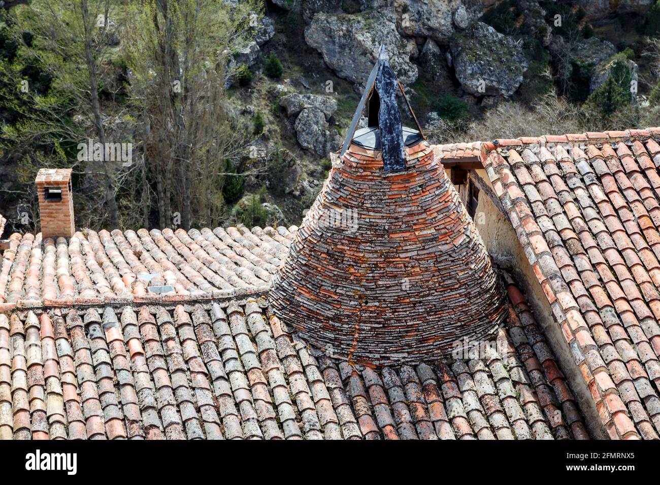 Conical chimney on a medieval tiled rooftop in Calatanazor, Spain Stock ...
