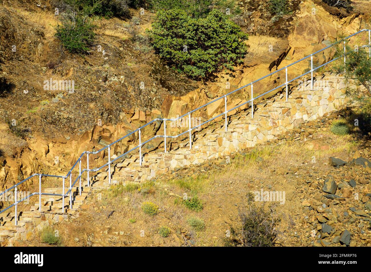 A steep stairway with metal safety handrail along the rocky Mount ...