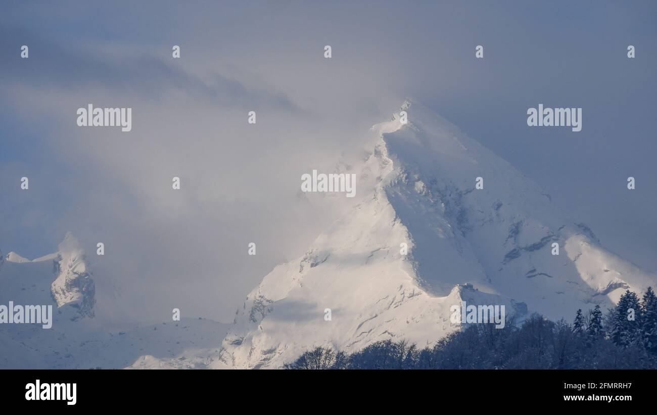 peak of Mt. Watzmann Hocheck in winter with clouds, bavarian alps ...