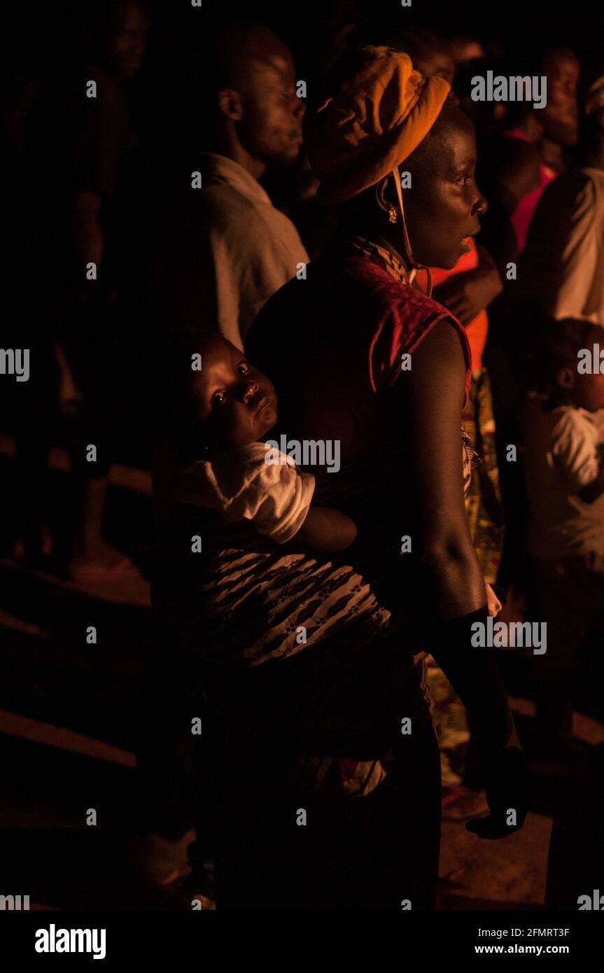 Mother with child in sling watching a traditional dance, Sapo buffer ...