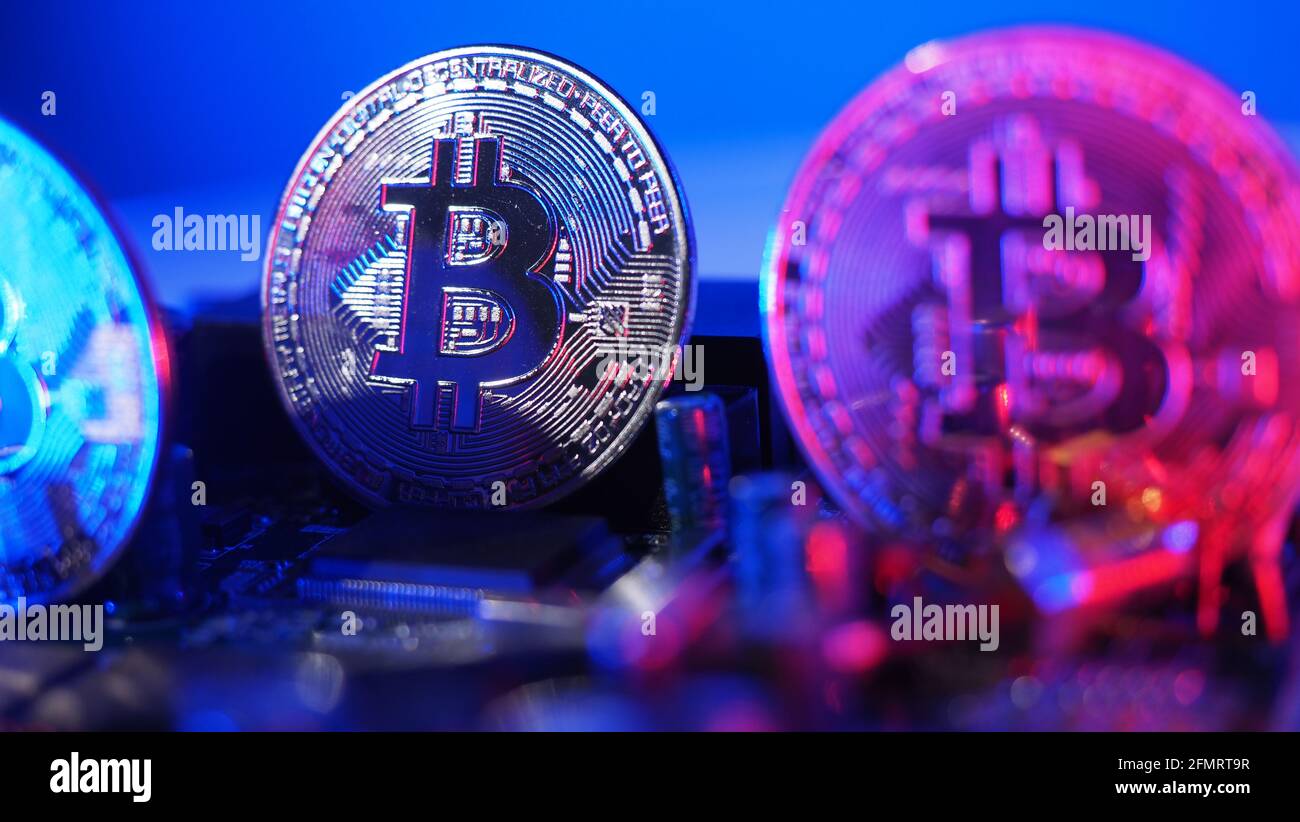 Cryptocurrency coins on circuit board. Bitcoins standing on CPU board ...