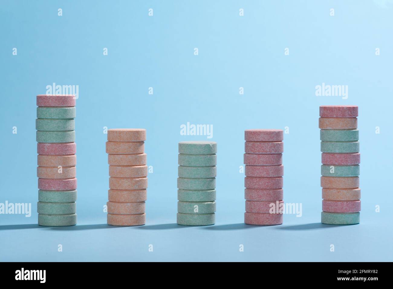 Columns of colourful tablets placed on a light blue background Stock ...