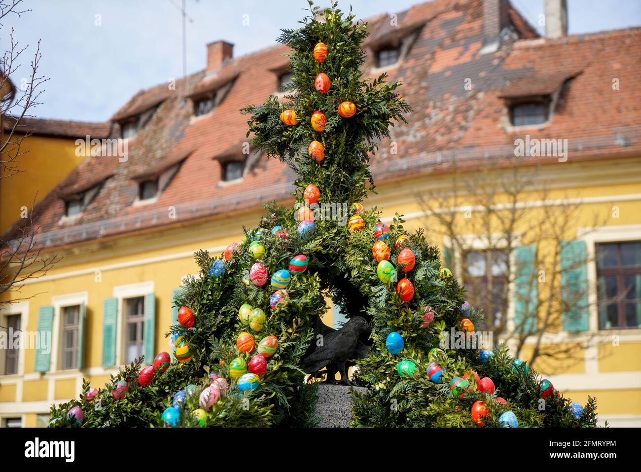 Easter is a religious festival with colored eggs and decorated bushes ...