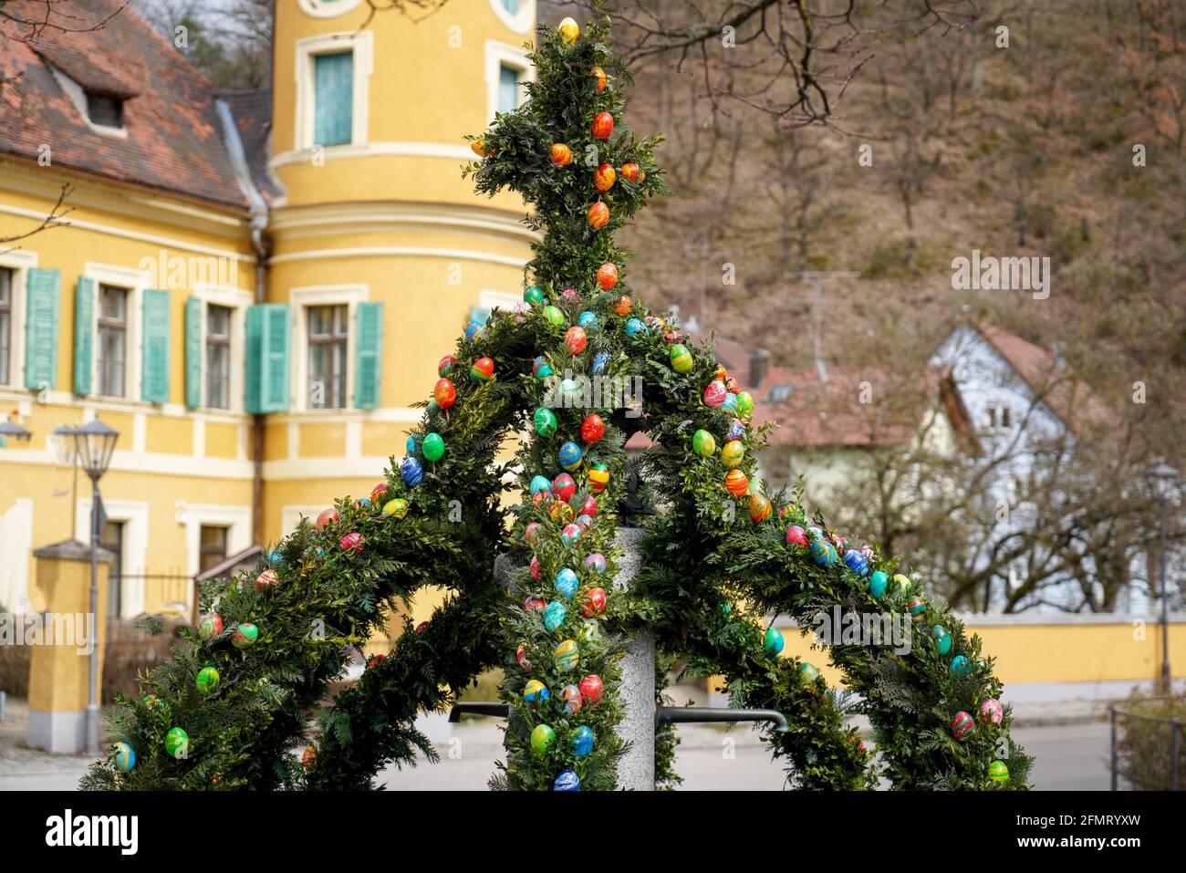 Easter is a religious festival with colored eggs and decorated bushes ...