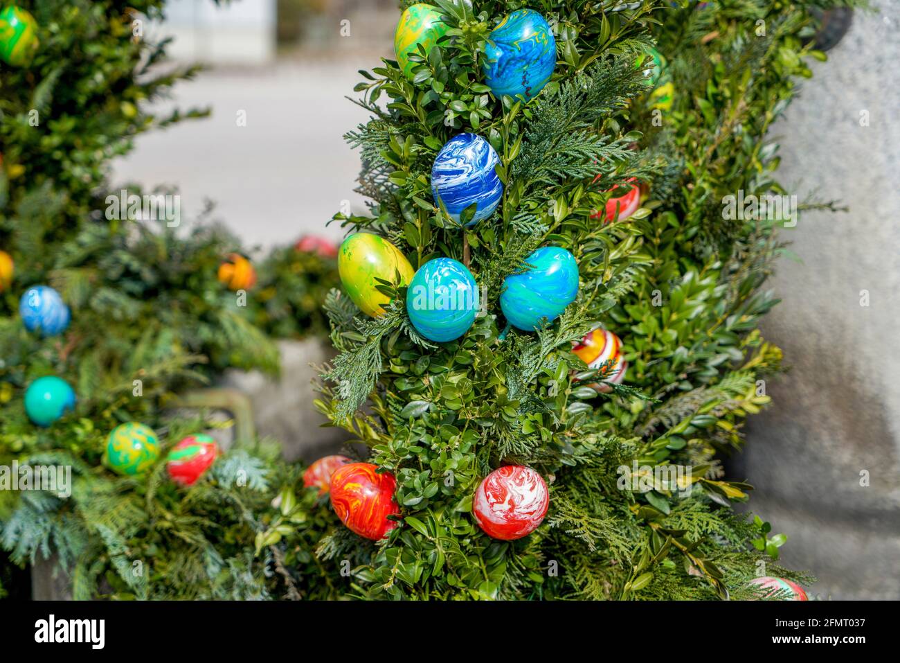 Easter is a religious festival with colored eggs and decorated bushes ...