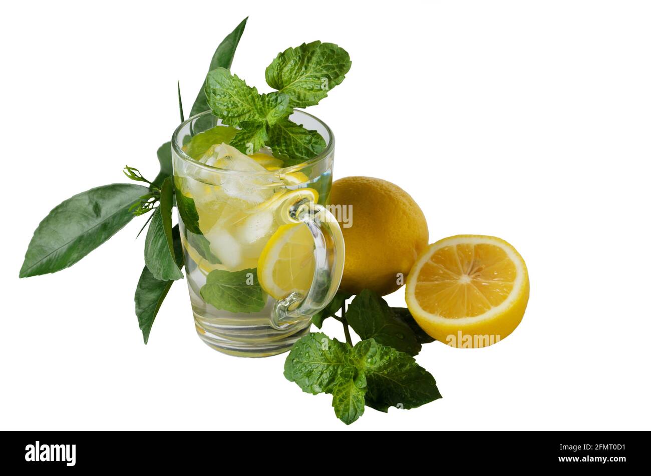 A glass glass of lemonade. Water with lemon slices, mint leaves and ice ...