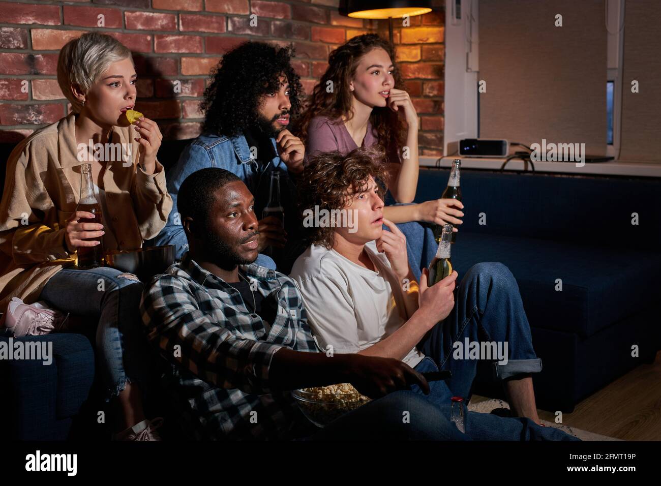 Concerned group of friends worry while watching sport game on tv ...