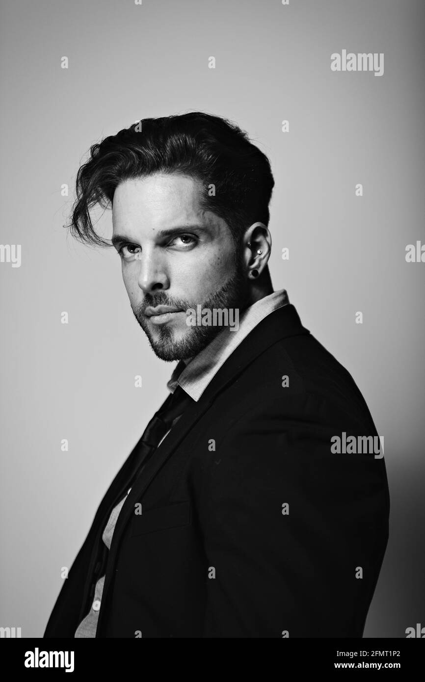 Grayscale shot of a handsome man posing in a studio Stock Photo - Alamy