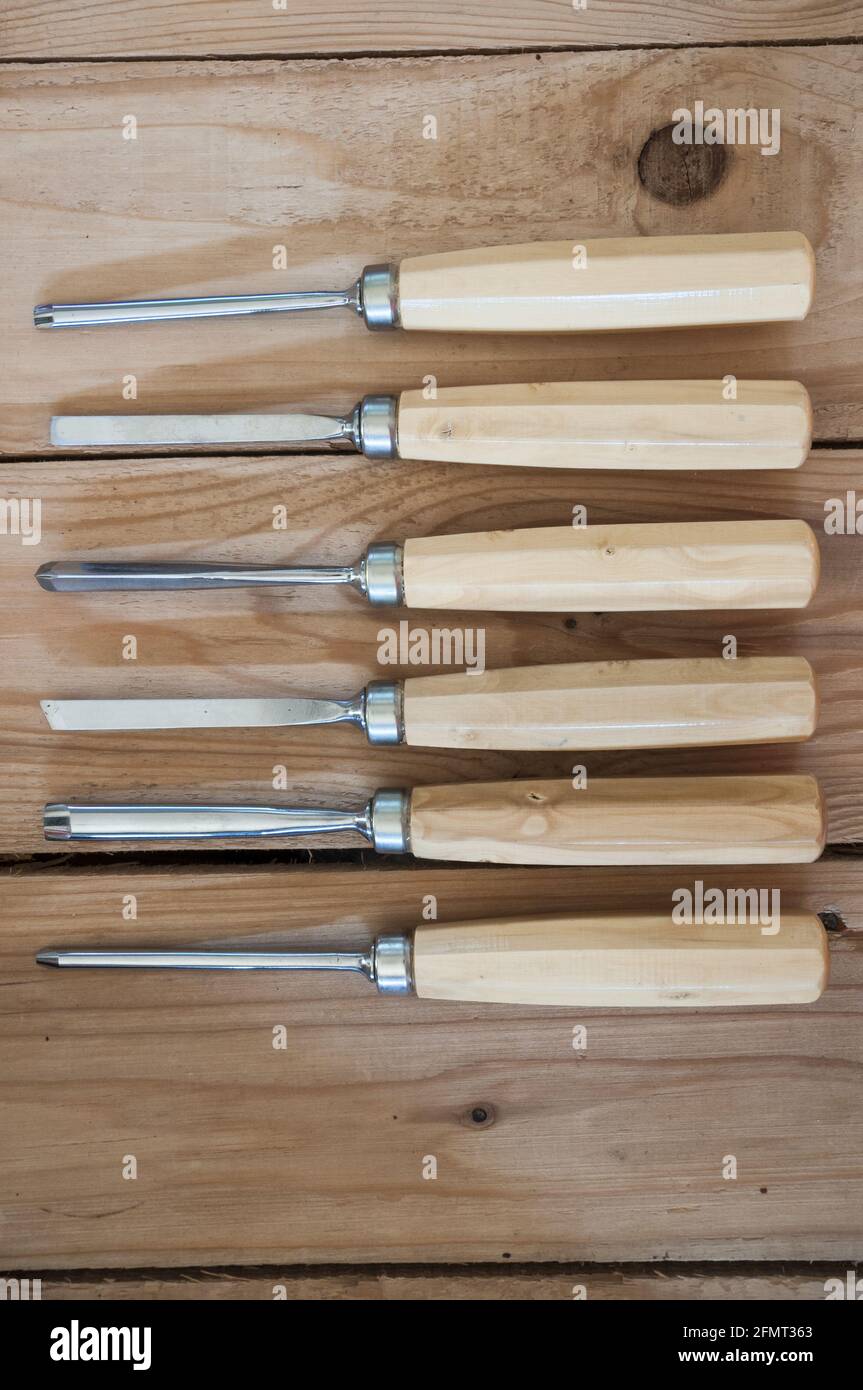 Vertical shot of gouges with wooden handles on a table Stock Photo - Alamy