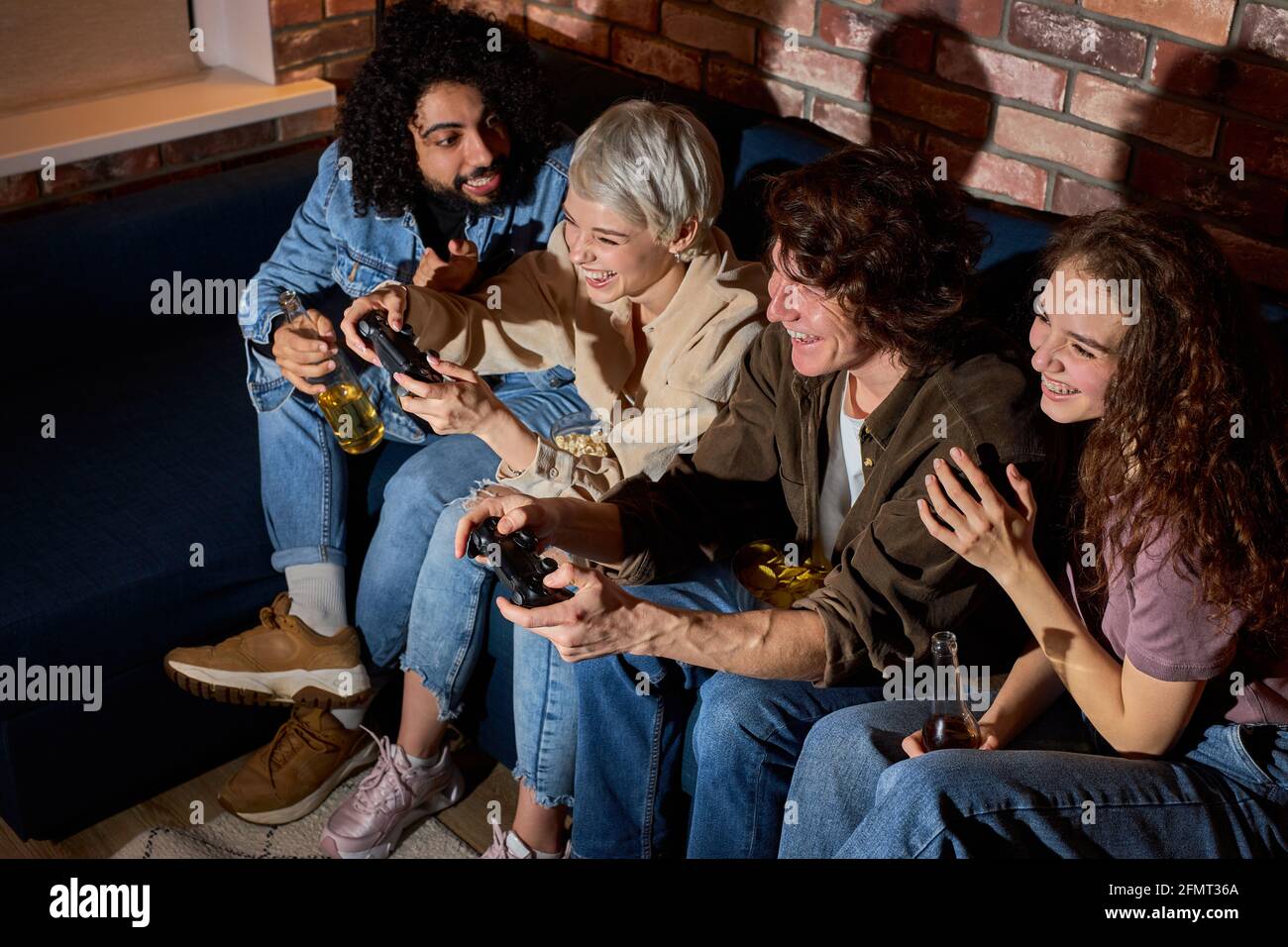 Crazy Young Friends Enjoying Playing Videogame In The Evening, Hold ...