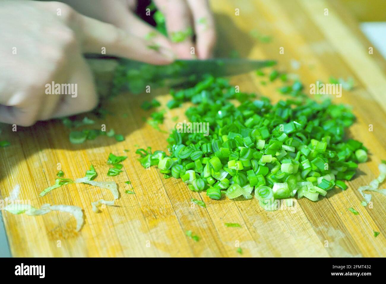 chopping green onions for salad for dinner, a person chopping green ...