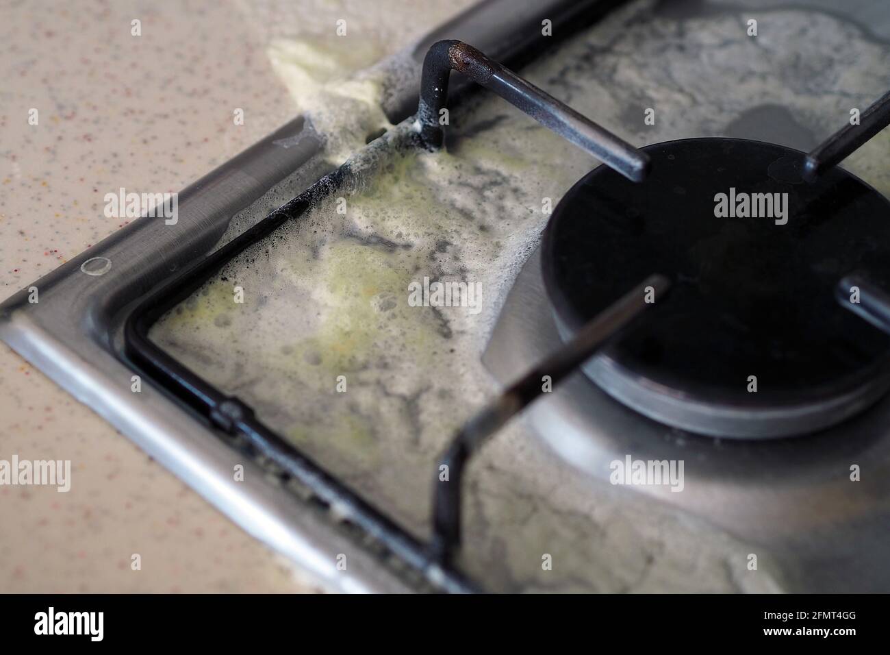 the cooker where milk spilled, the cooking stove where milk spilled was ...
