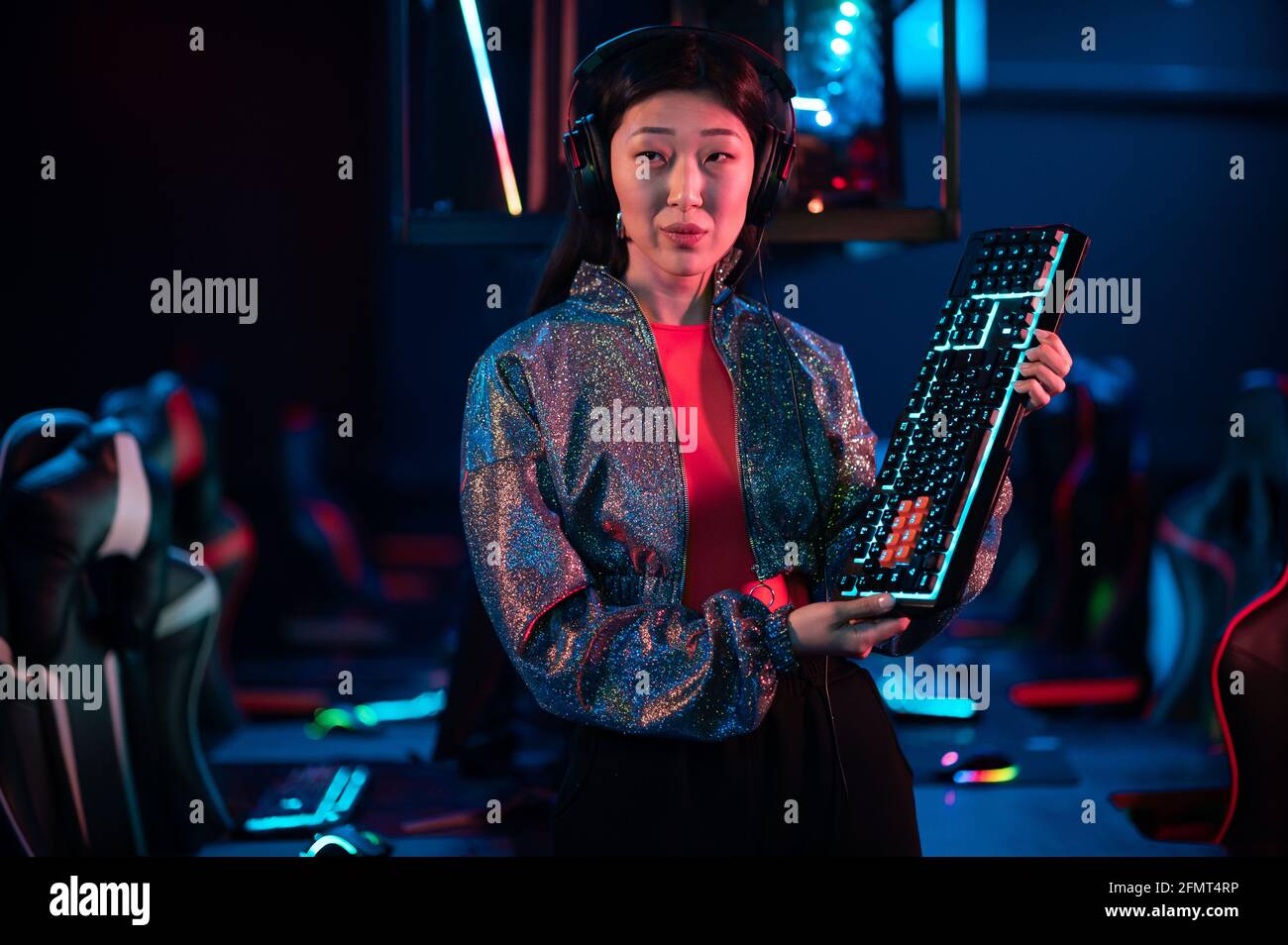An experienced asian gamer shows a gaming keyboard and talks about its ...