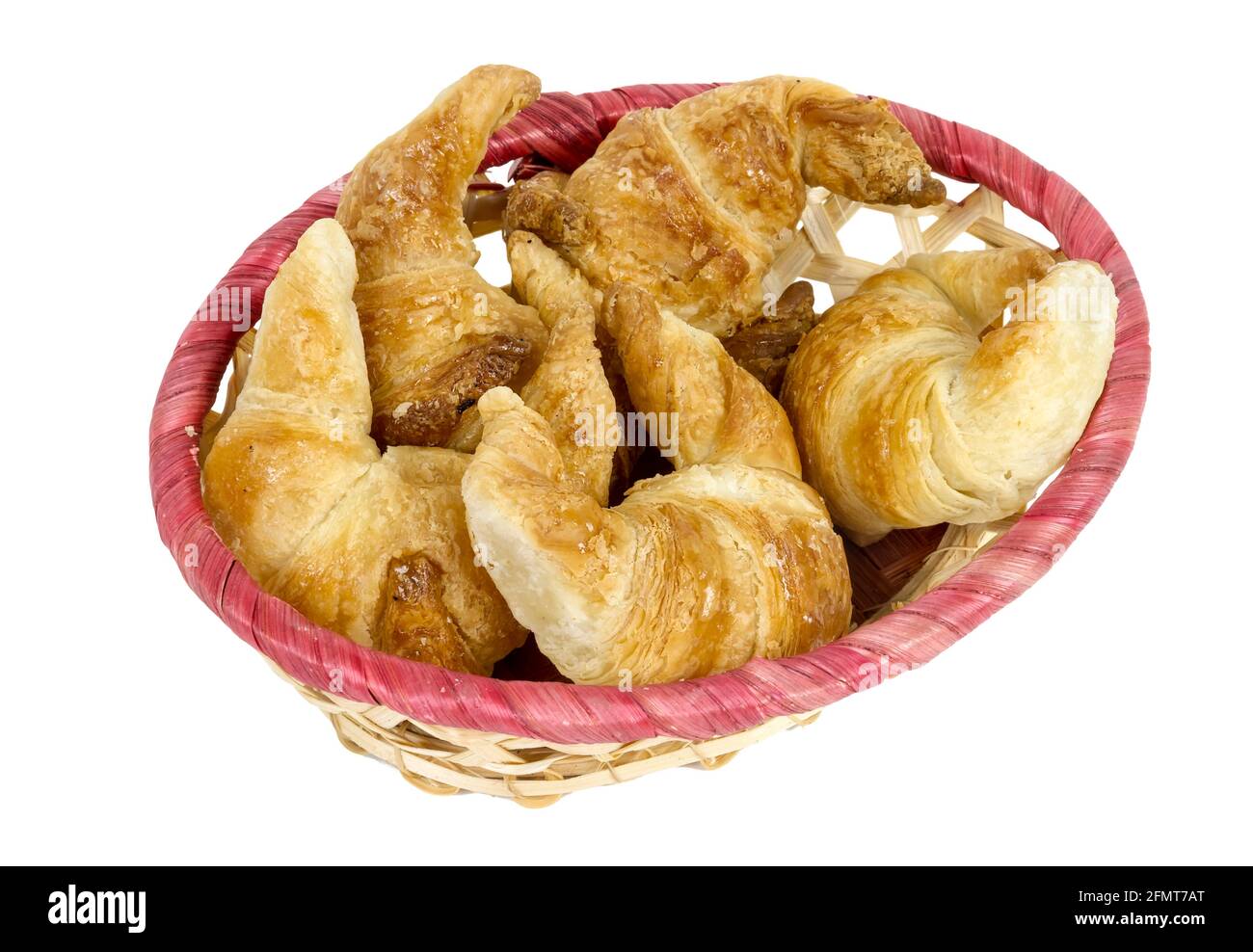 Buns, croissants, bread sticks in a wicker basket isolated on white ...