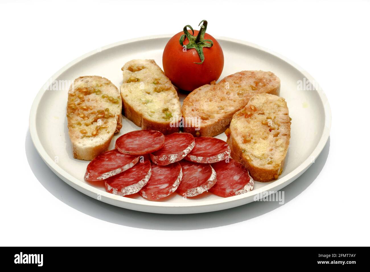 Catalan-style tomato rubbed on a slice of bread with oil and salt point ...