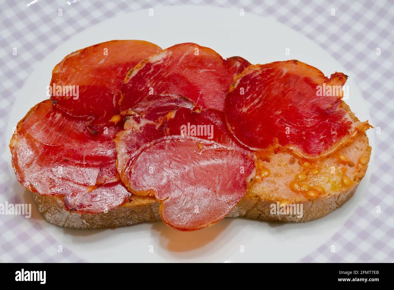 Spanish Catalan-style tomato spread on a slice of bread with oil and ...