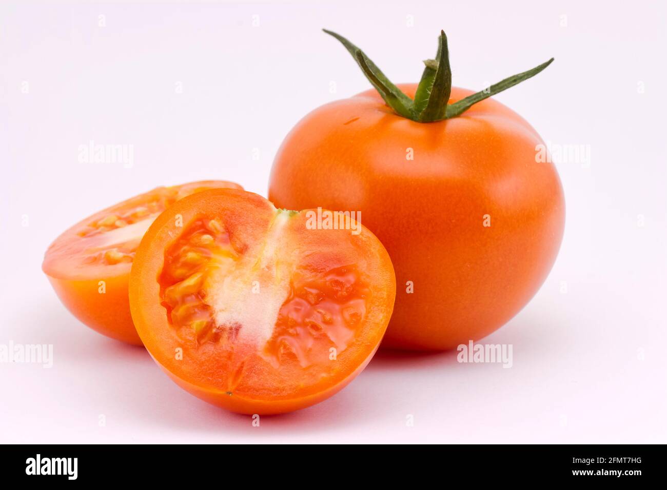 three red tomato vegetable isolated on white background Stock Photo - Alamy