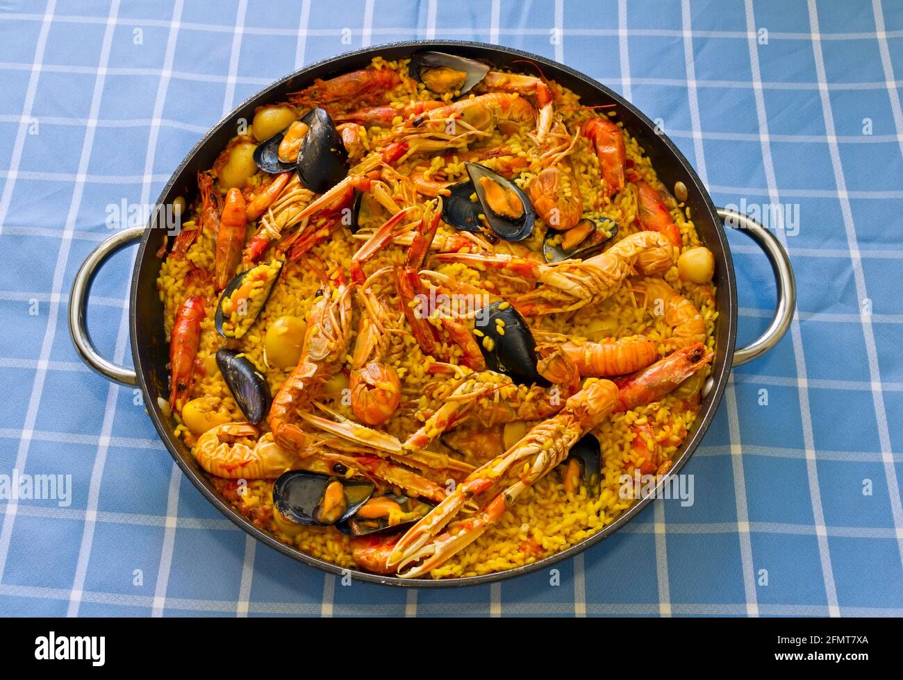 Paella Valenciana, typical food of Spain, based on rice and seafood ...