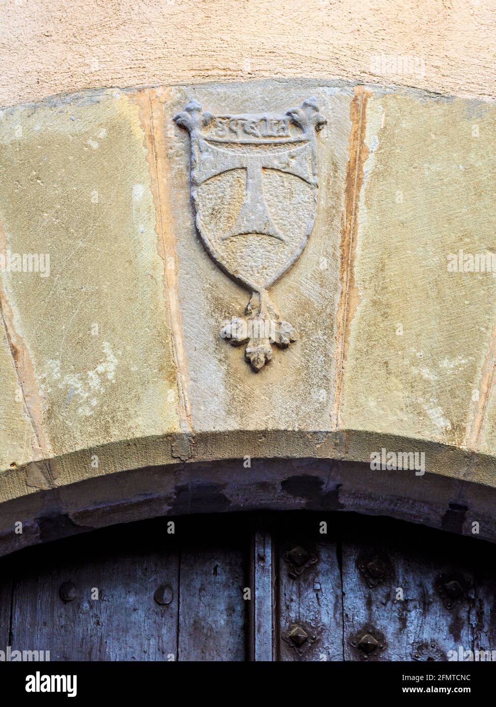 Tao cross detail at the entrance of the Church, Santa Tecla, Montblanc ...