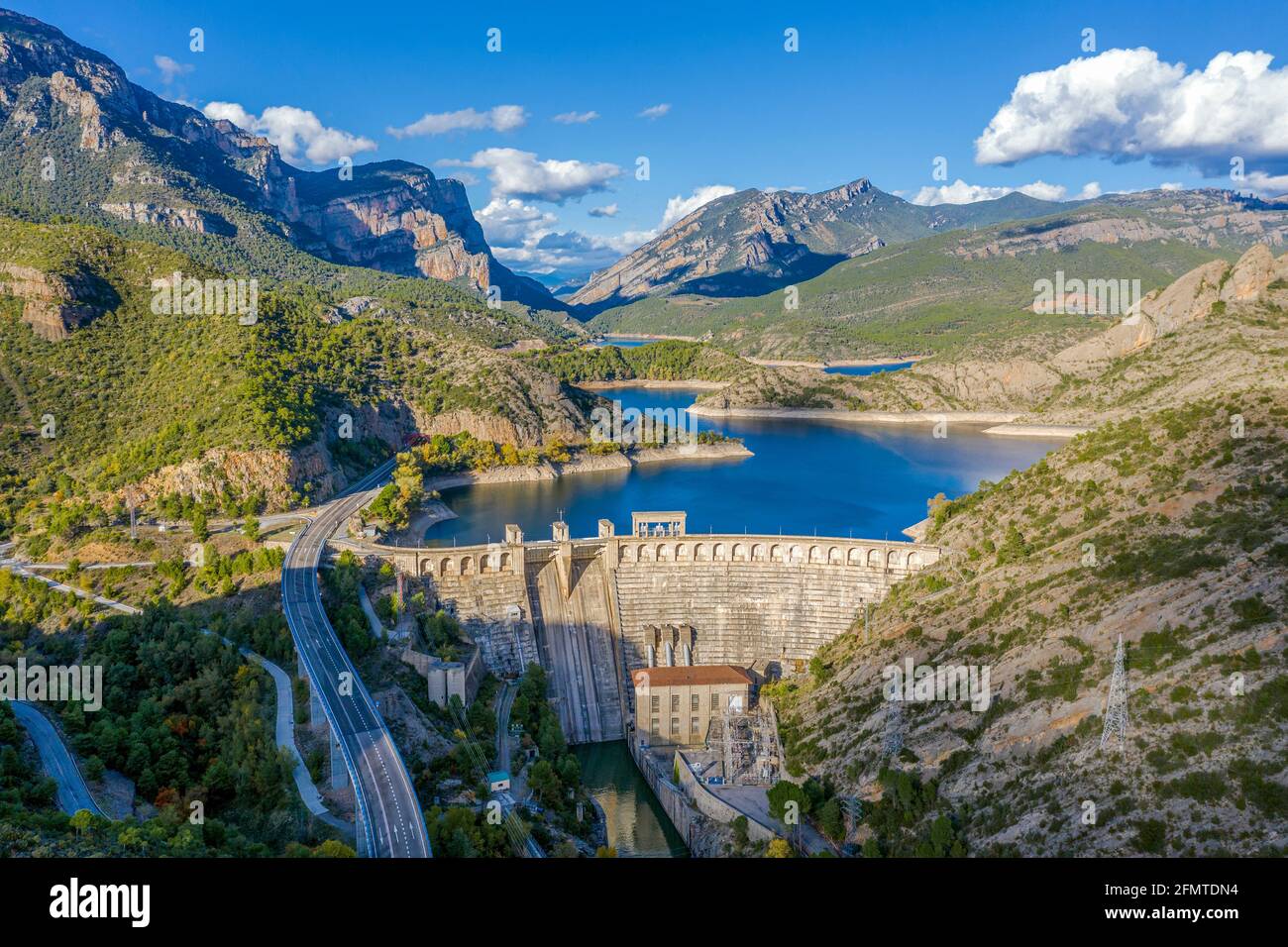 View of hydro-electric power station and a highway. Dam at Segre river ...