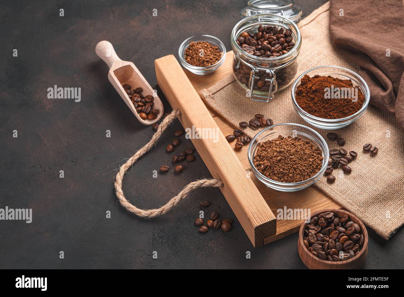 Coffee of different types on a board on a brown background. Side view ...