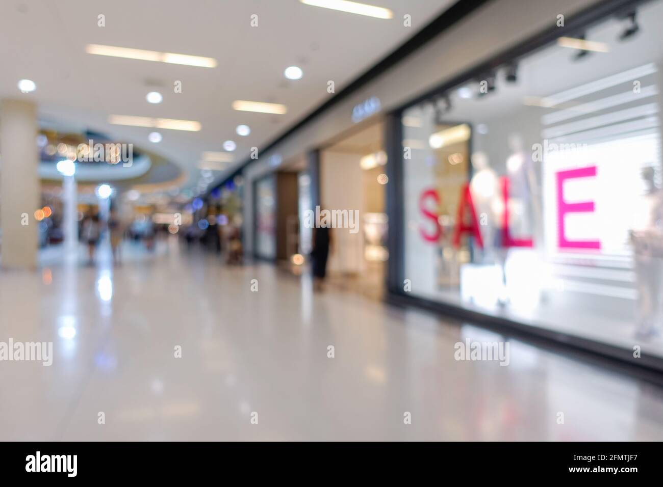 Blurred image of shopping mall and people walking for background usage ...