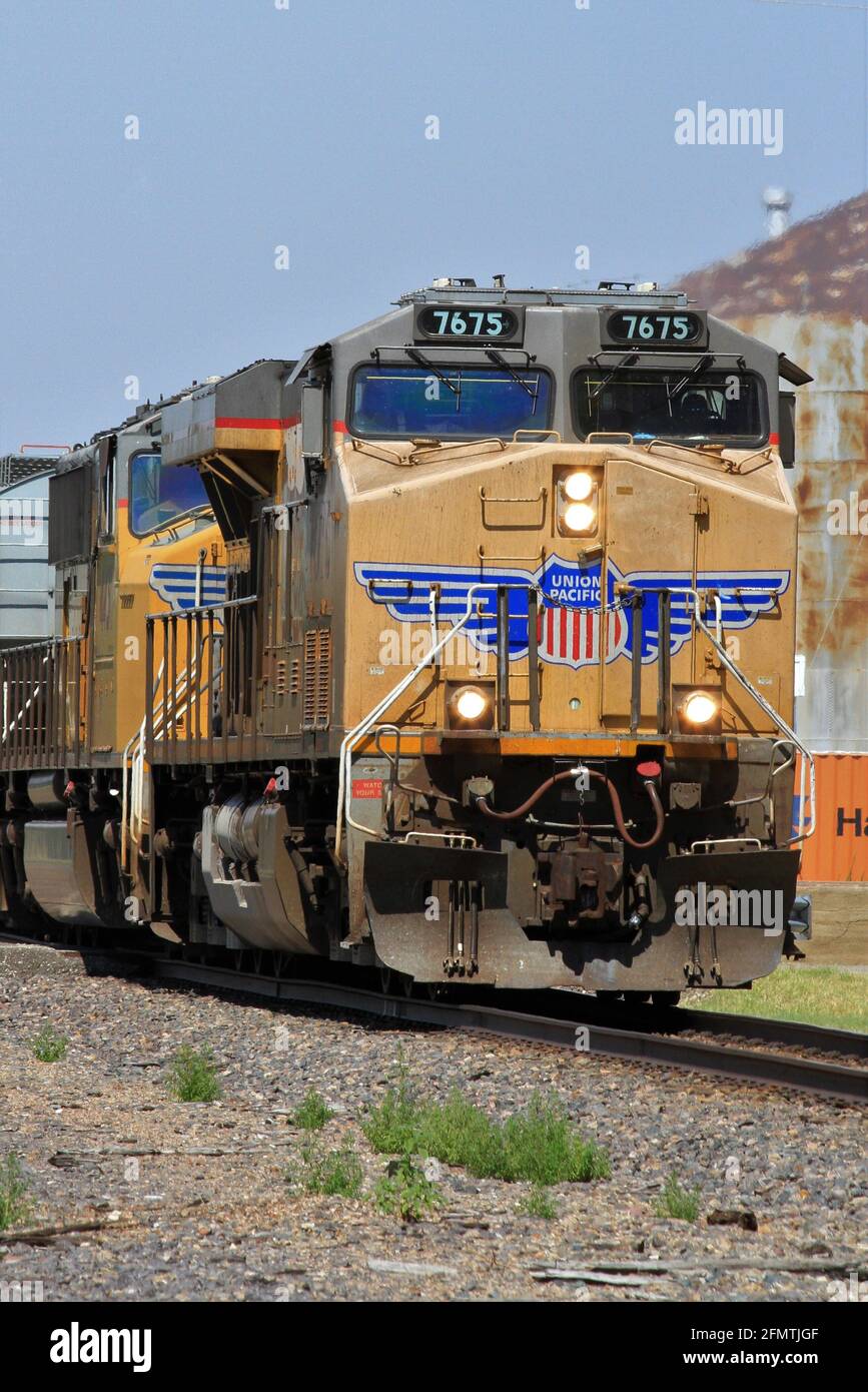 Union Pacific Train on the train track with blue sky and green weeds ...