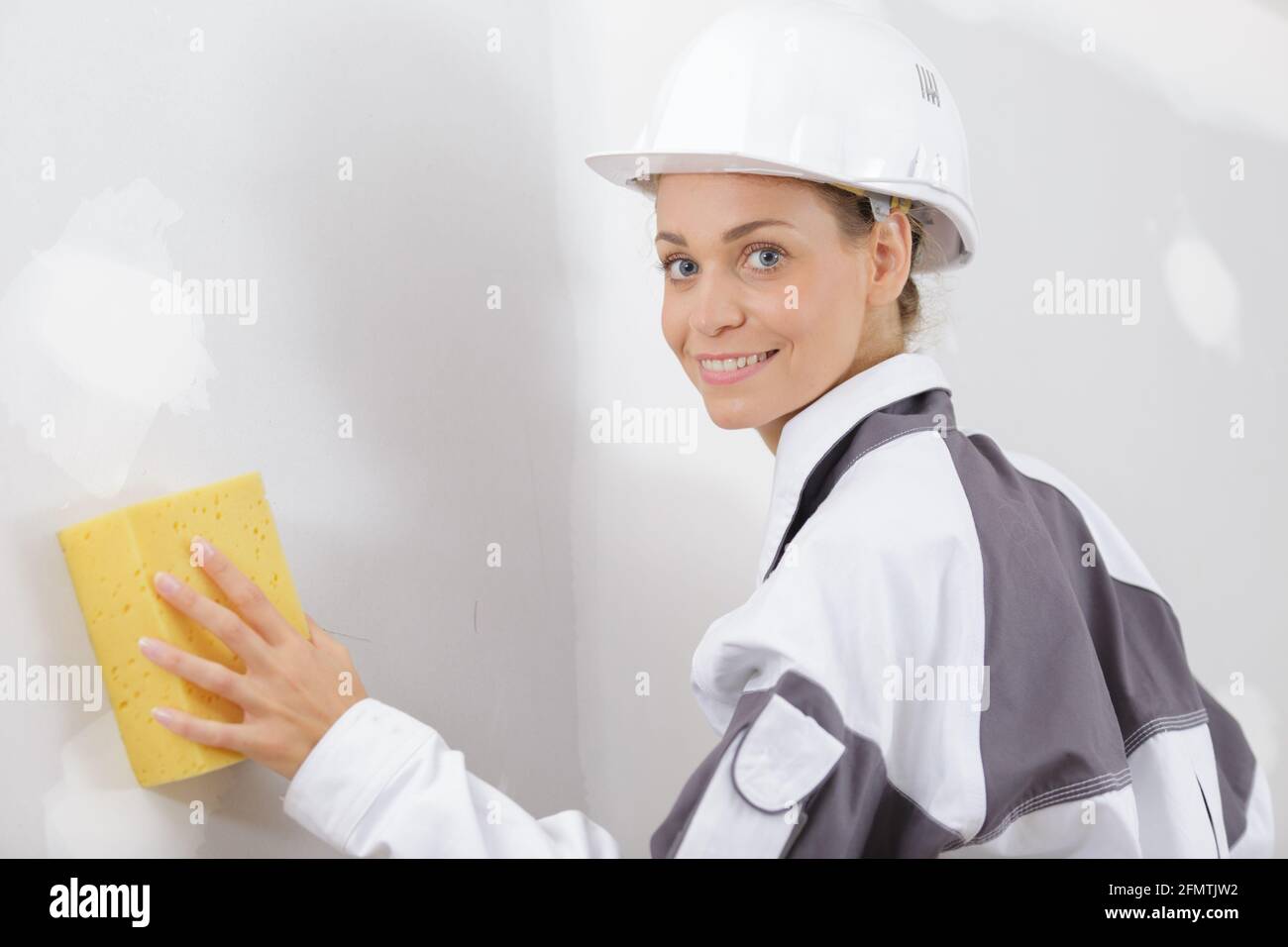 portrait of a woman cleaning wall Stock Photo - Alamy