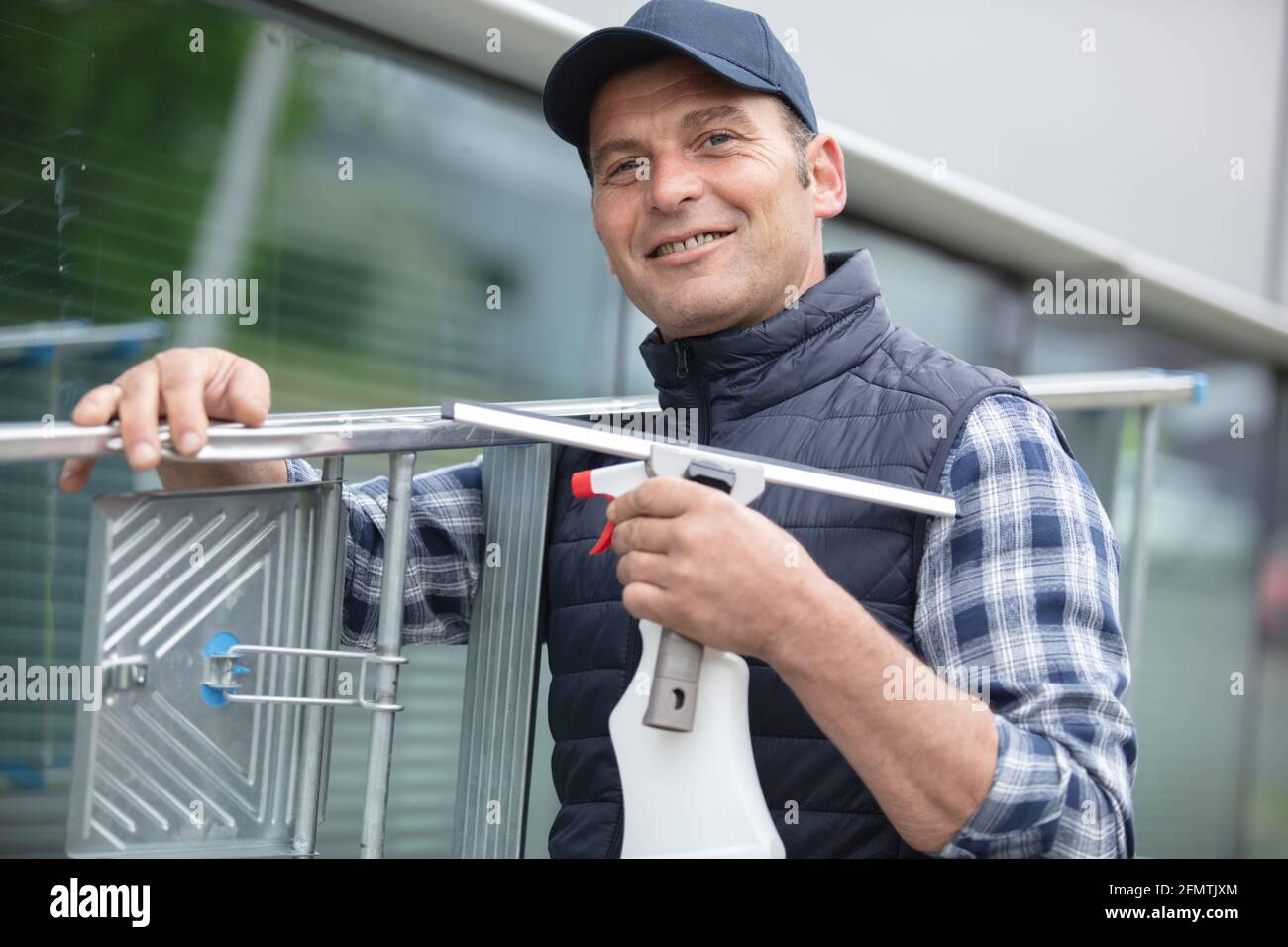 window cleaner holding ladder and smiling Stock Photo - Alamy
