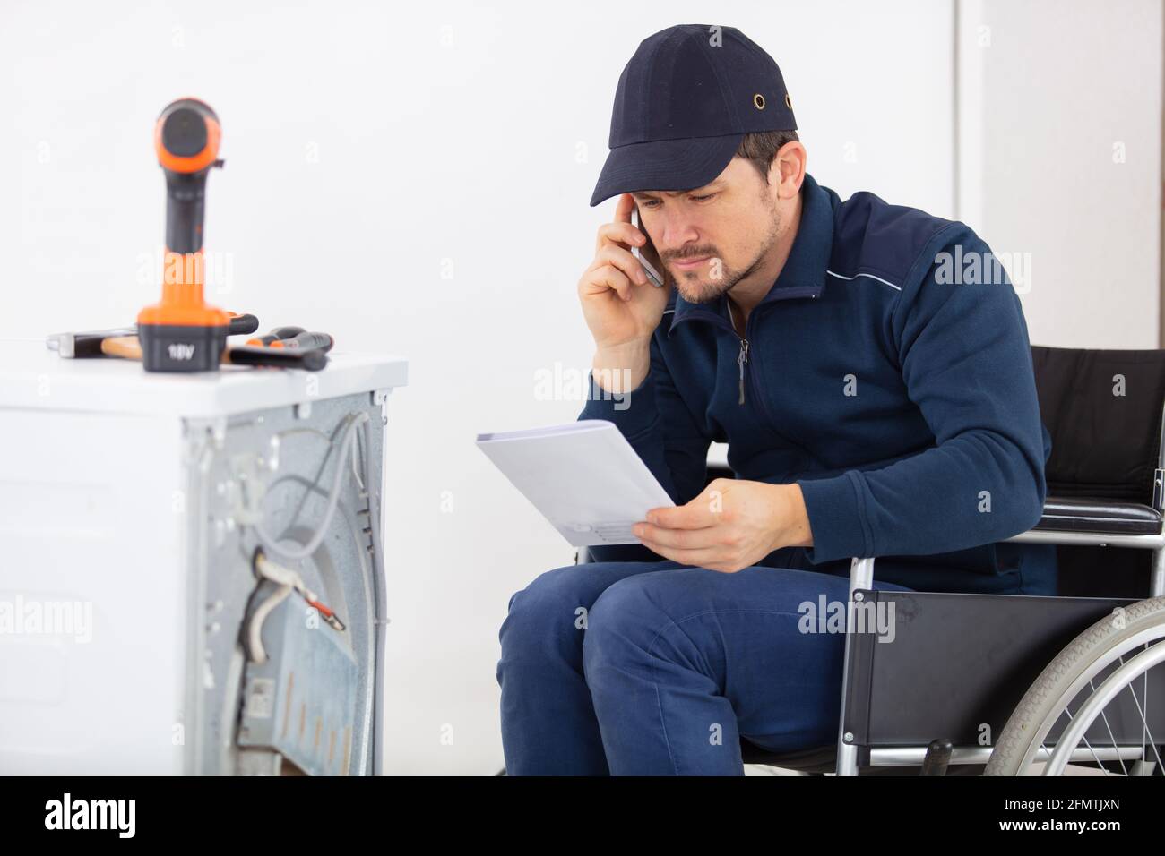 disabled worker in wheelchair in his worksho Stock Photo - Alamy