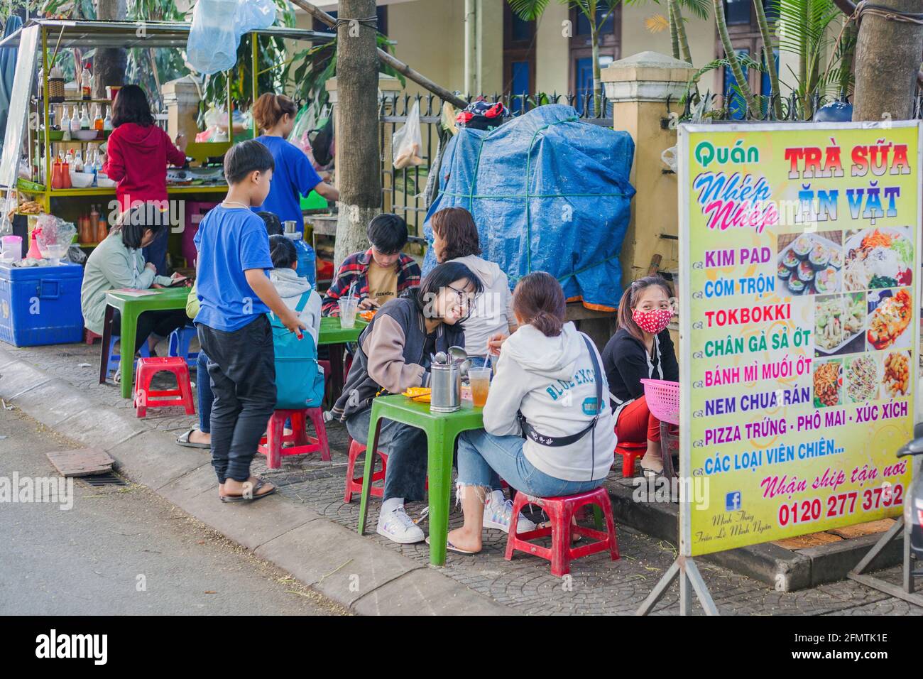Vietnamese families seated at pavement cafe, Hoi An, Vietnam Stock ...