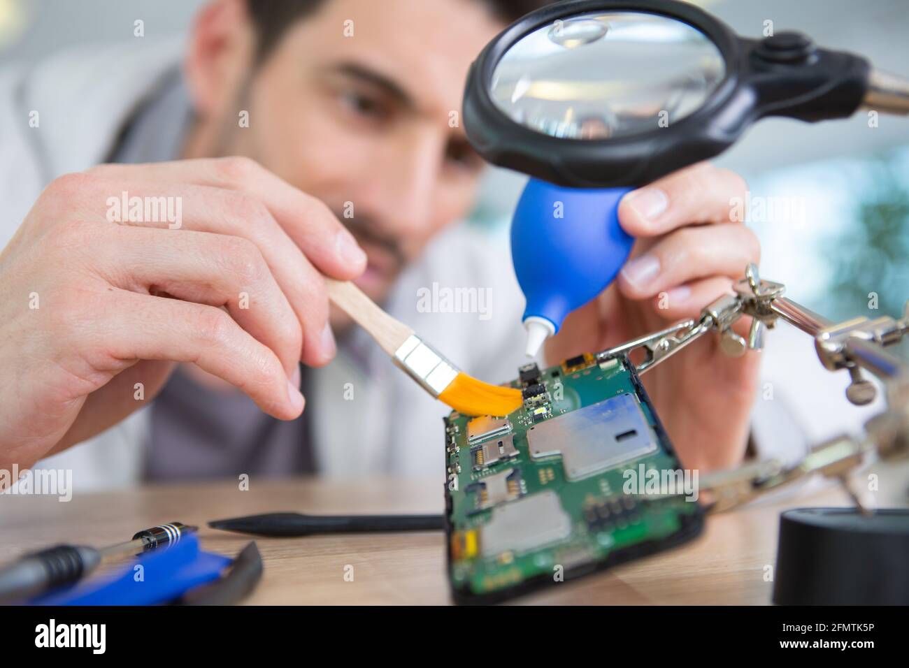 Male tech repairs electronic equipment hi-res stock photography and ...