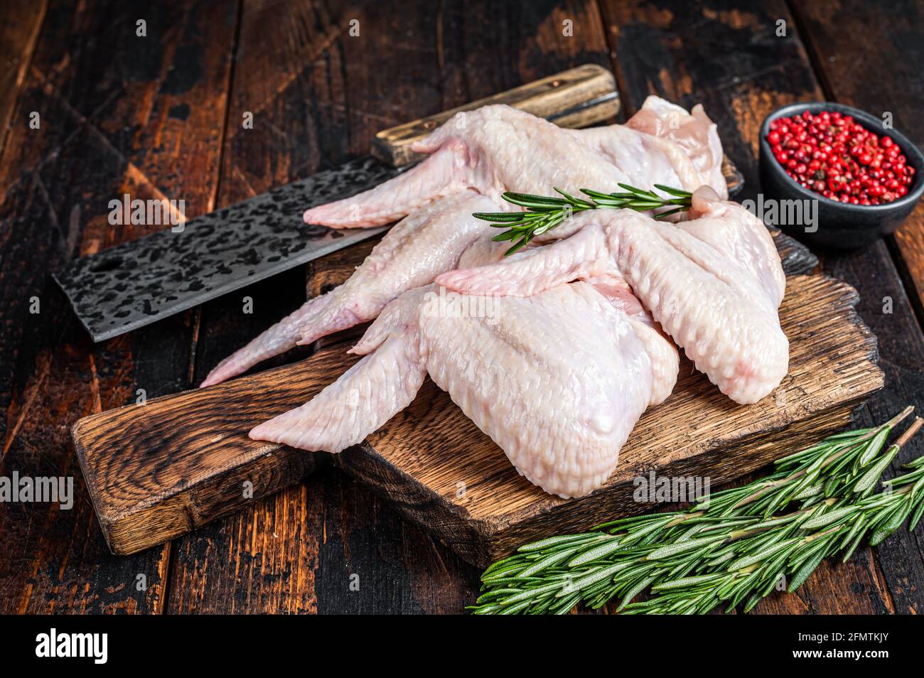Uncooked Raw chicken wings Poultry meat on a butchery board with meat ...