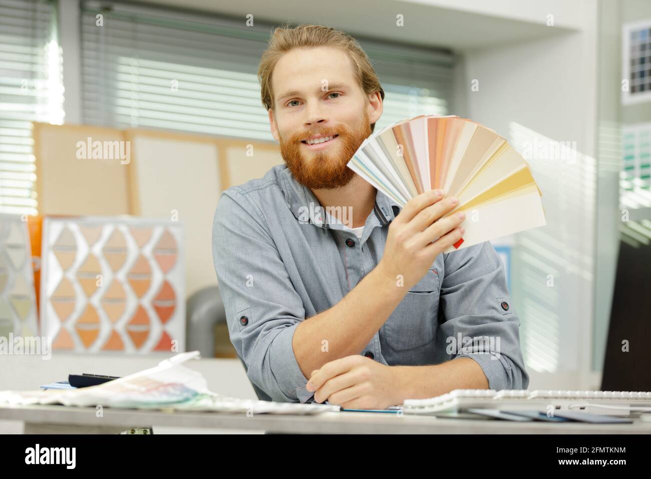 male worker showing colour swatches to camera Stock Photo - Alamy