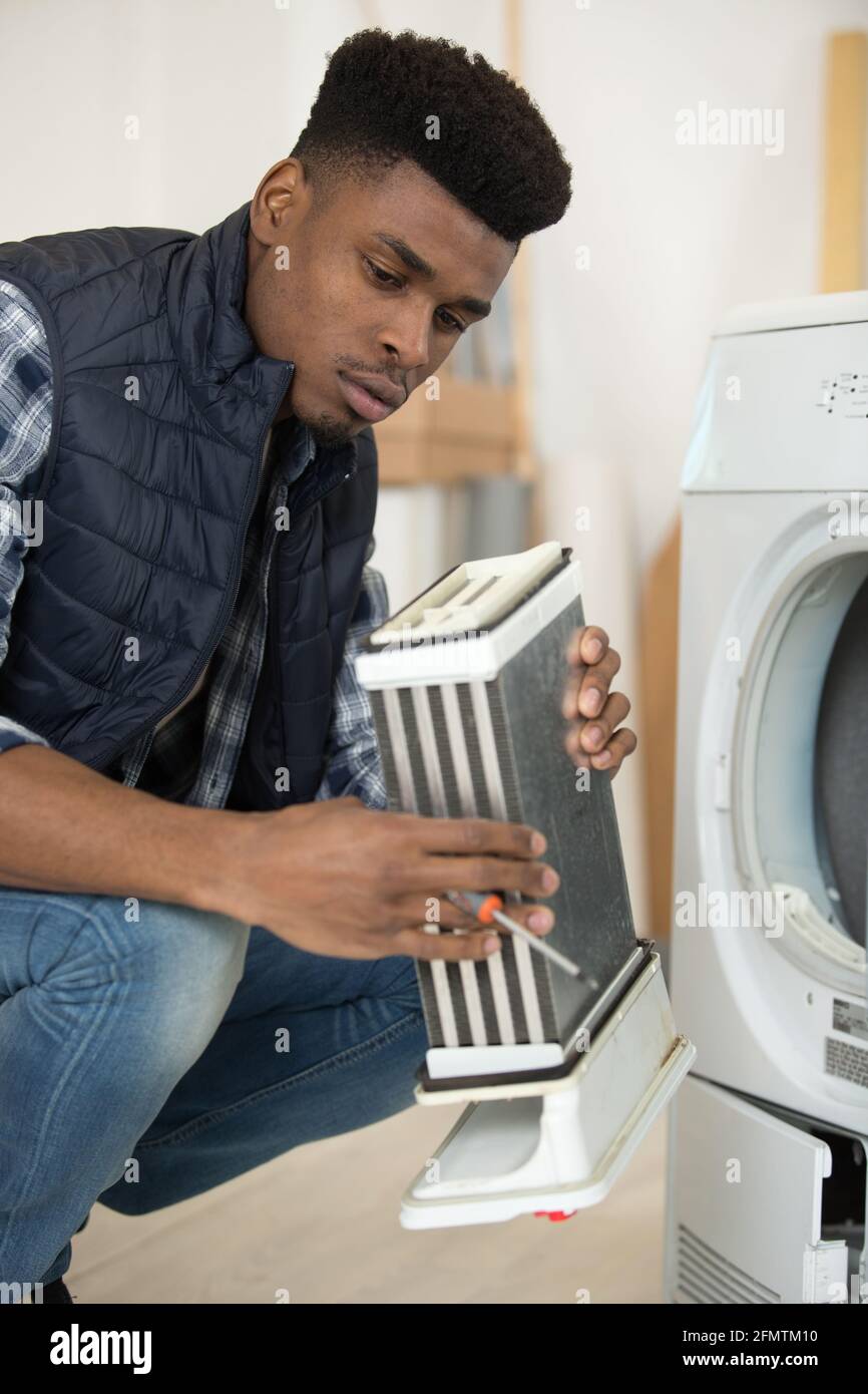 serious man fixing washing machine Stock Photo - Alamy